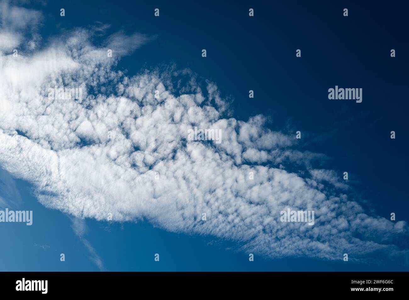Background of clear blue sky and white cloud touching sunlight in ...