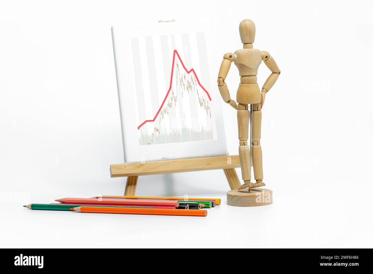 Mannequin drawing a graph charts on easel; isolated on white background ...