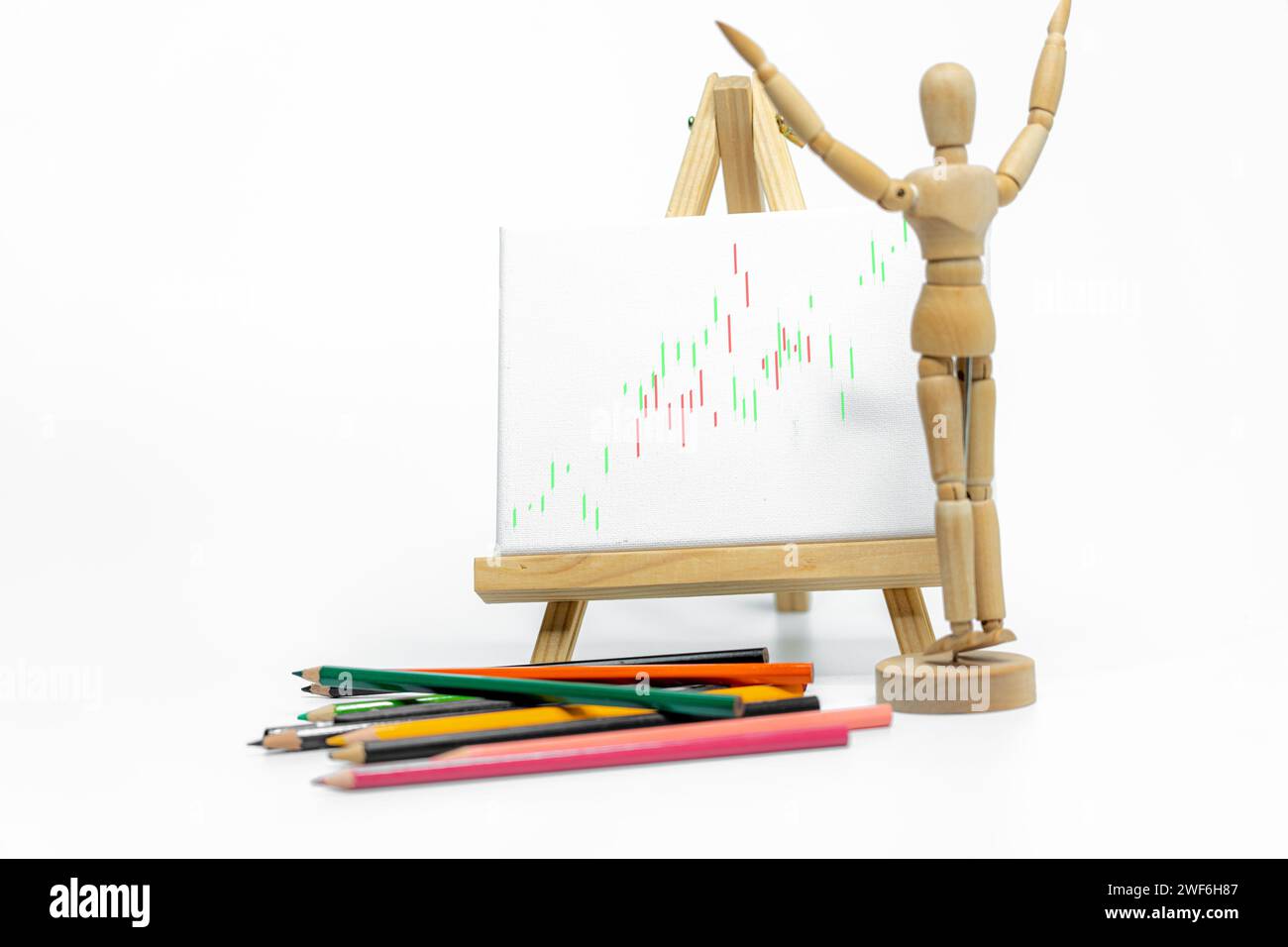 Mannequin drawing a graph charts on easel; isolated on white background ...