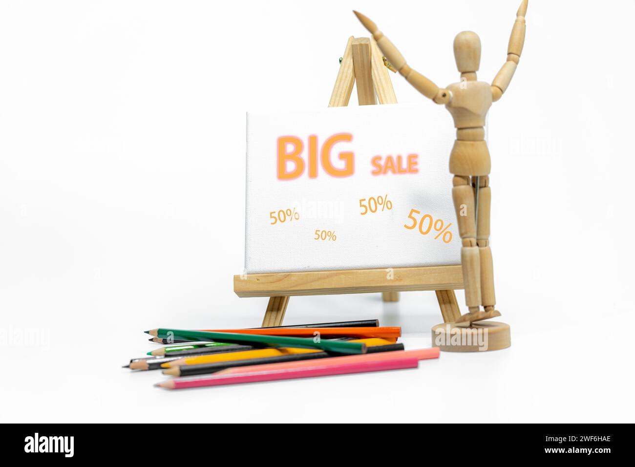 Mannequin drawing a SALE on easel; isolated on white background ...
