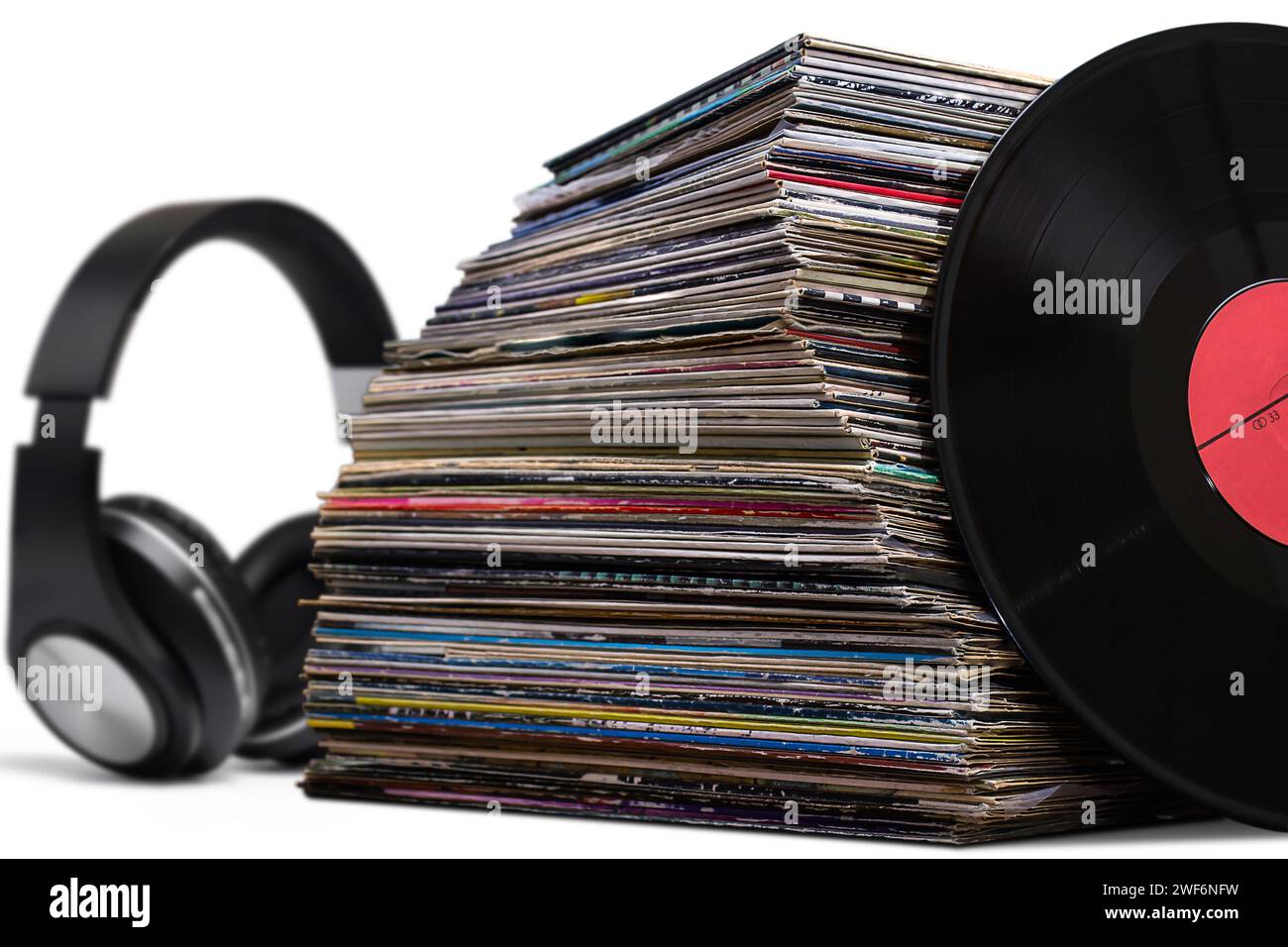 pile of old vinyl discs and headphones isolated on white background ...