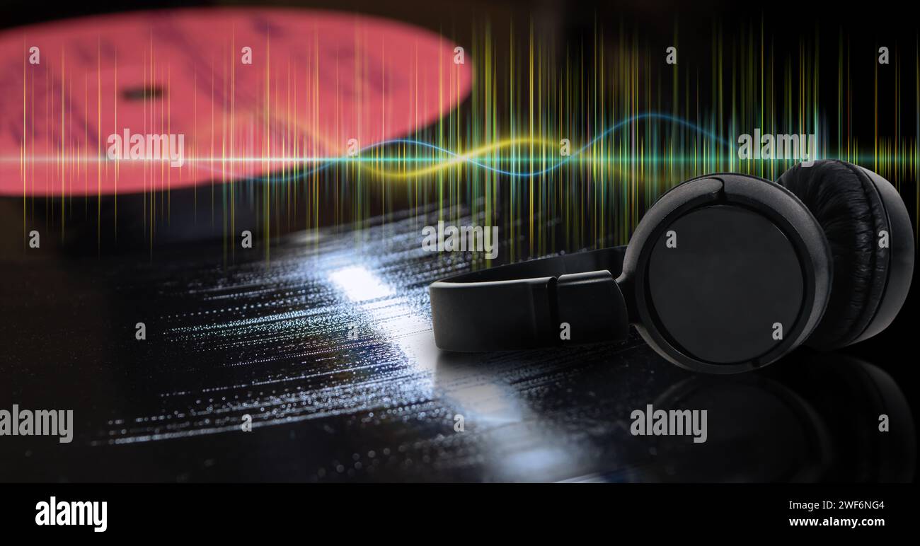 Headphones and sound wave on background of macro photo of vinyl record ...