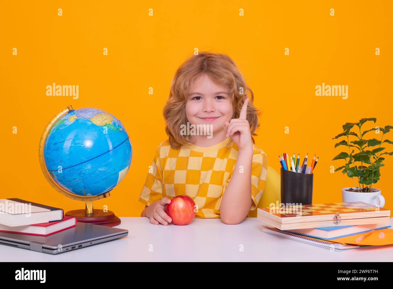 School kid holding index finger up with great new idea. School kids ...