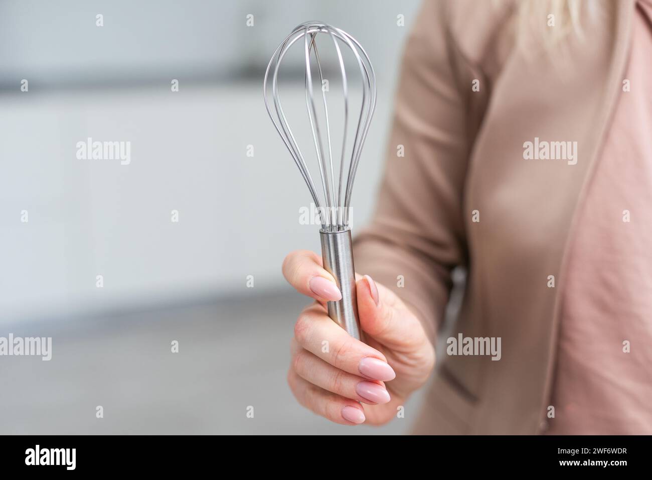 Female holding in hand whisk isolated on white background. Clipping ...