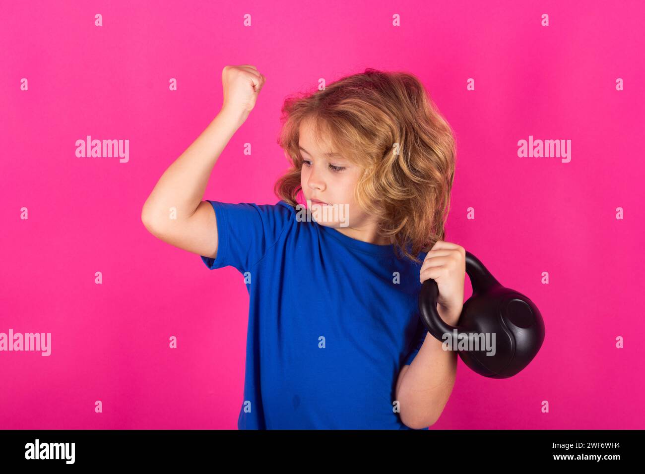 Kid with kettlebell in studio on red pink background. Kids sports ...