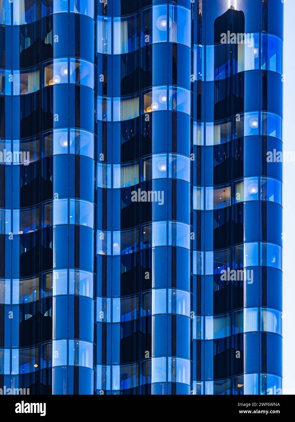 This photo captures a detailed close up of a towering modern skyscraper ...