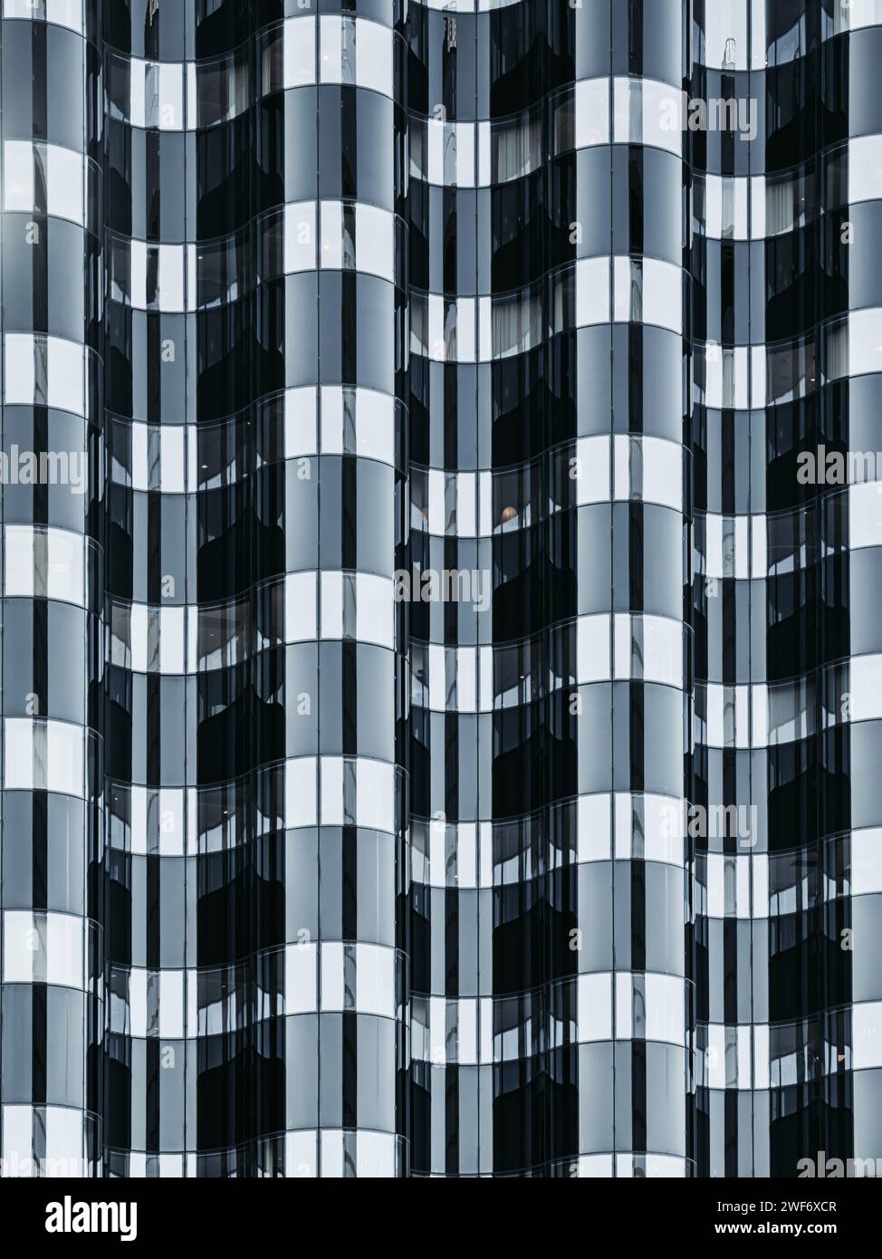 This photo captures a detailed close up of a towering modern skyscraper ...
