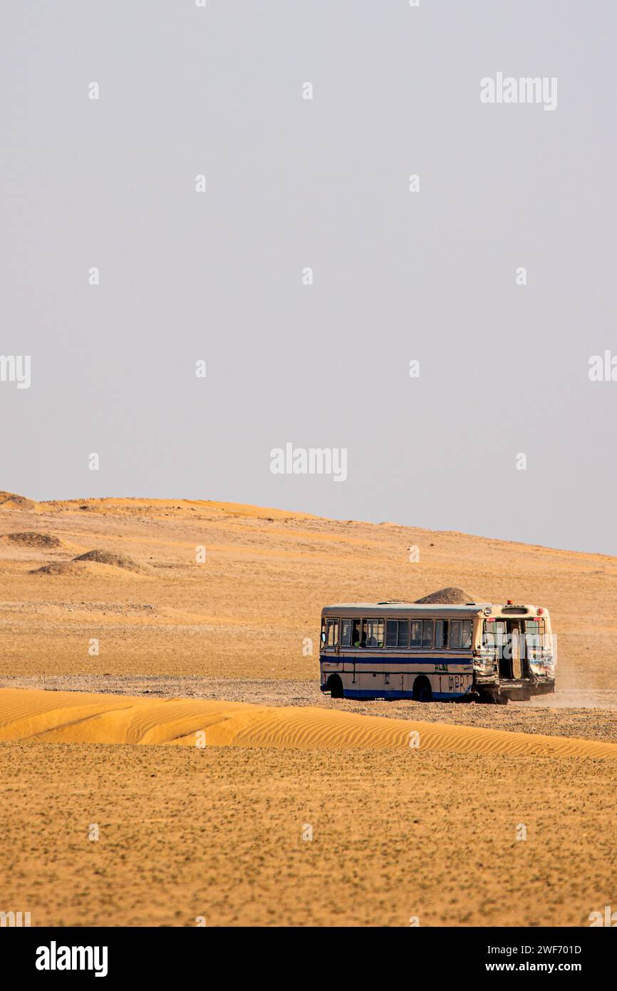 An old bus pictured in a desert landscape Stock Photo - Alamy