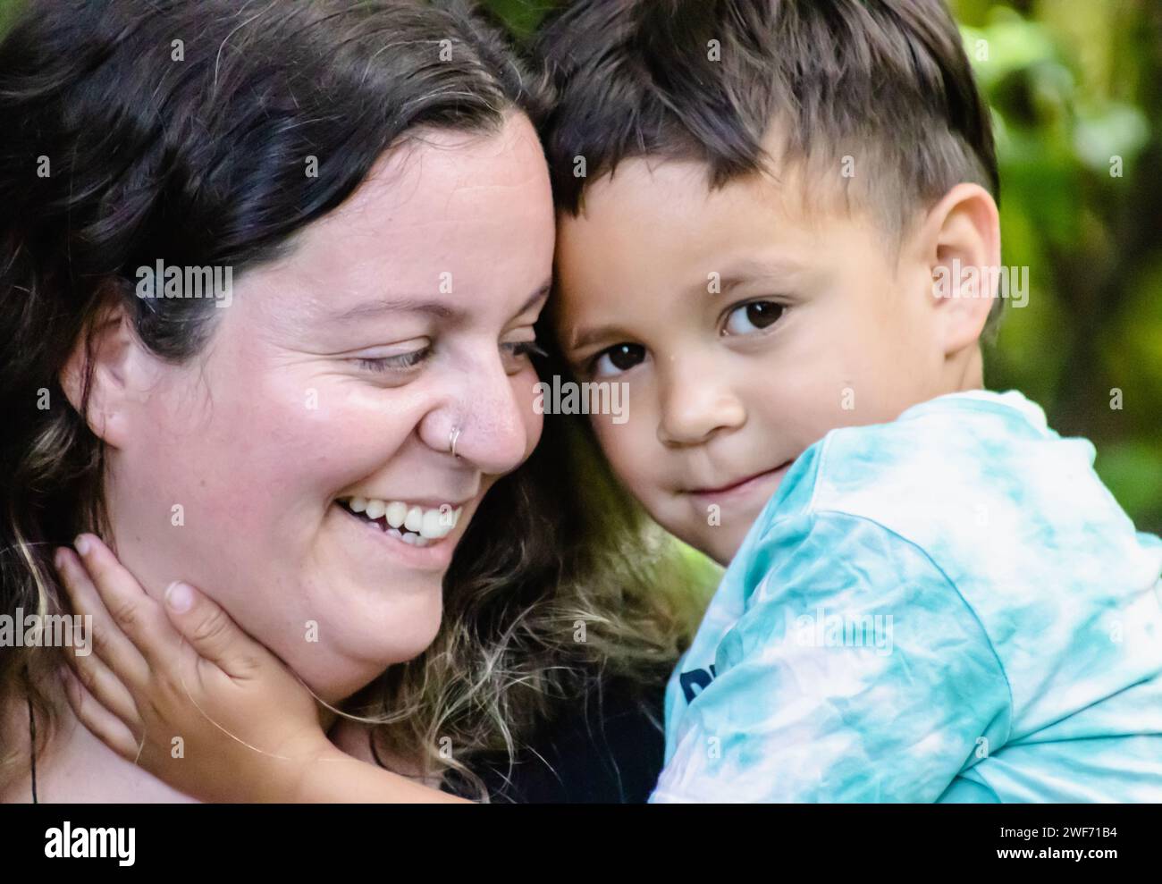 a close up image of a young Maori boy posing for a photograph with his ...
