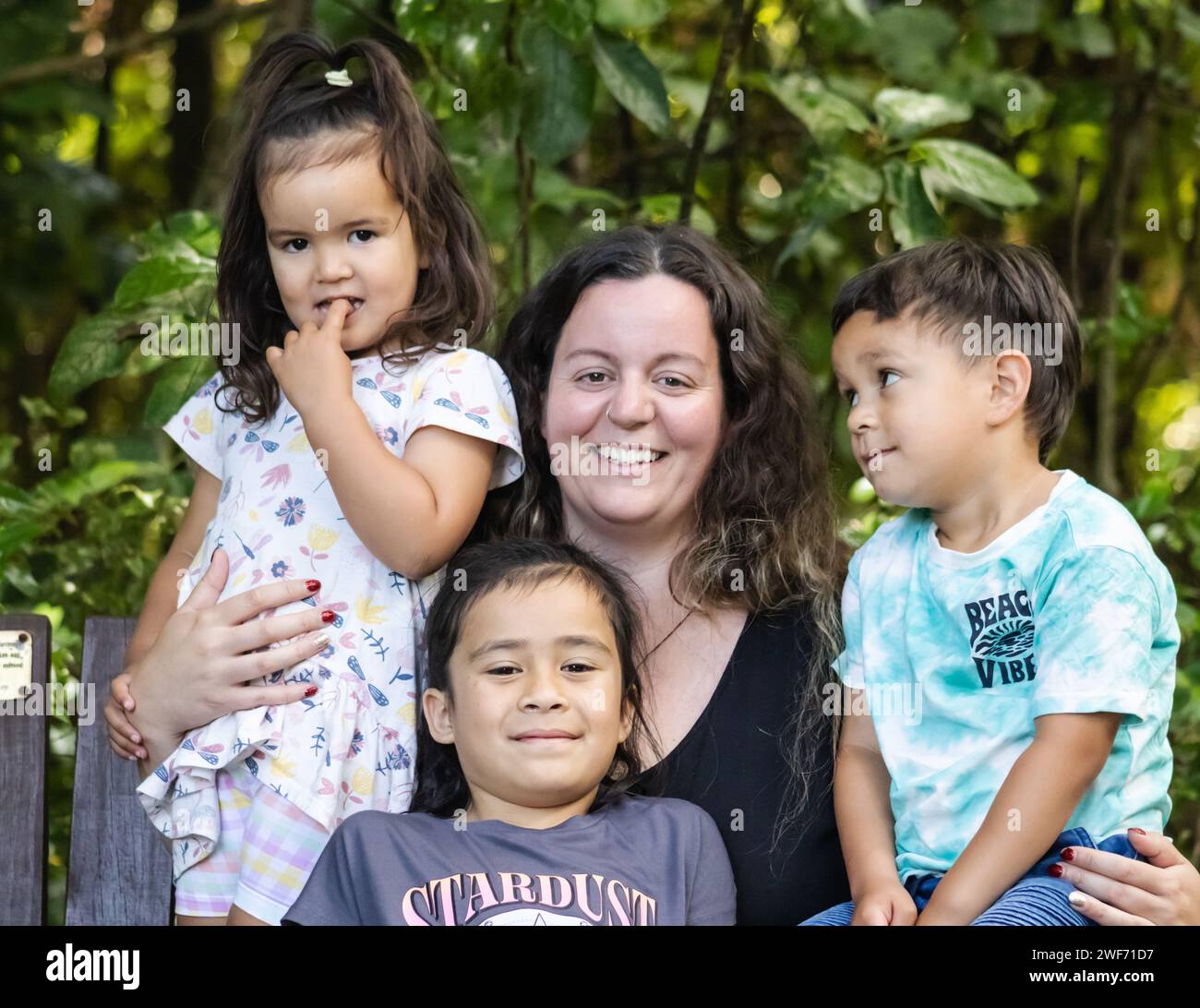 A close up image of a multiracial young family in New Zealand posing ...