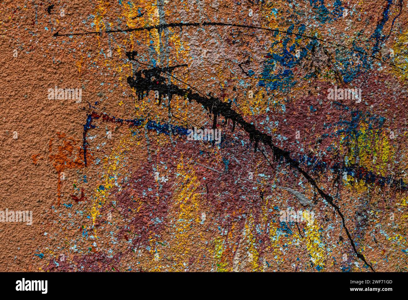 White plastered wall splattered with red paint. Paint splashes on the ...