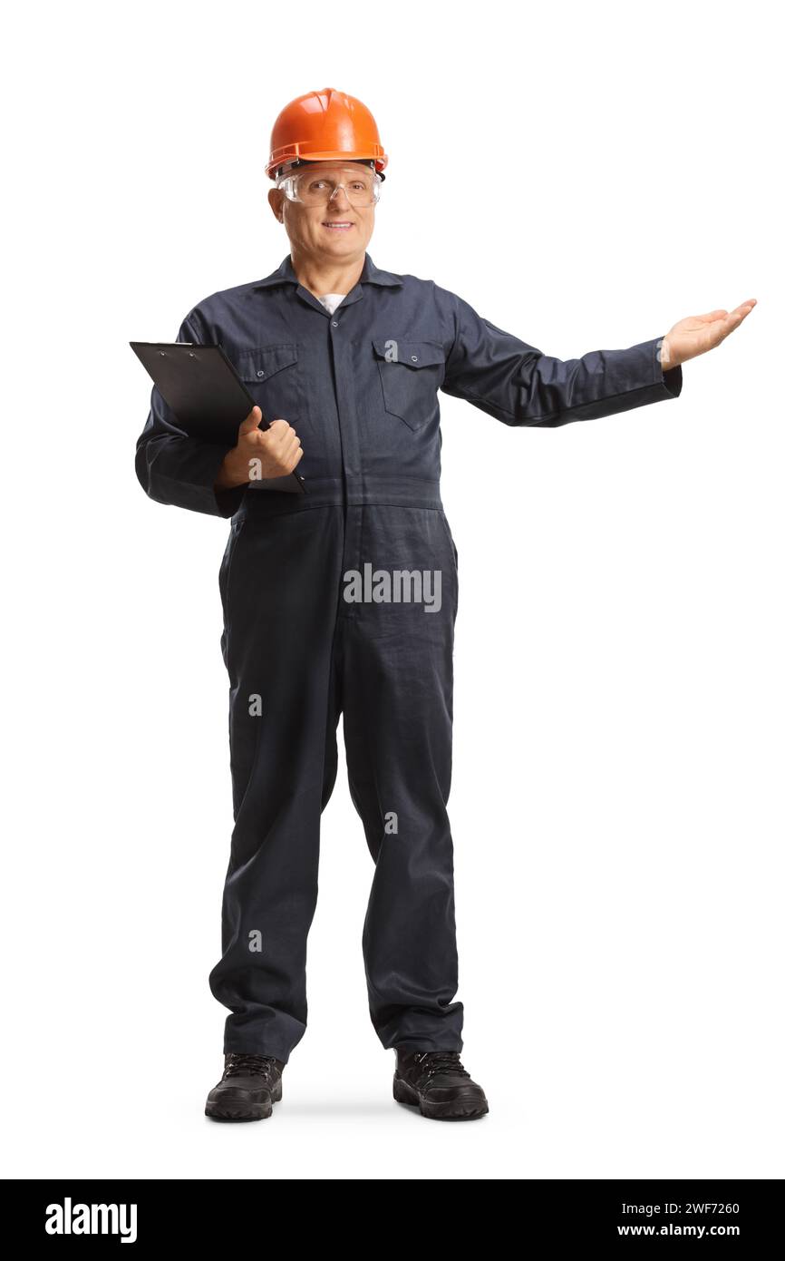 Male factory worker in an overall uniform and orange helmet holding a ...