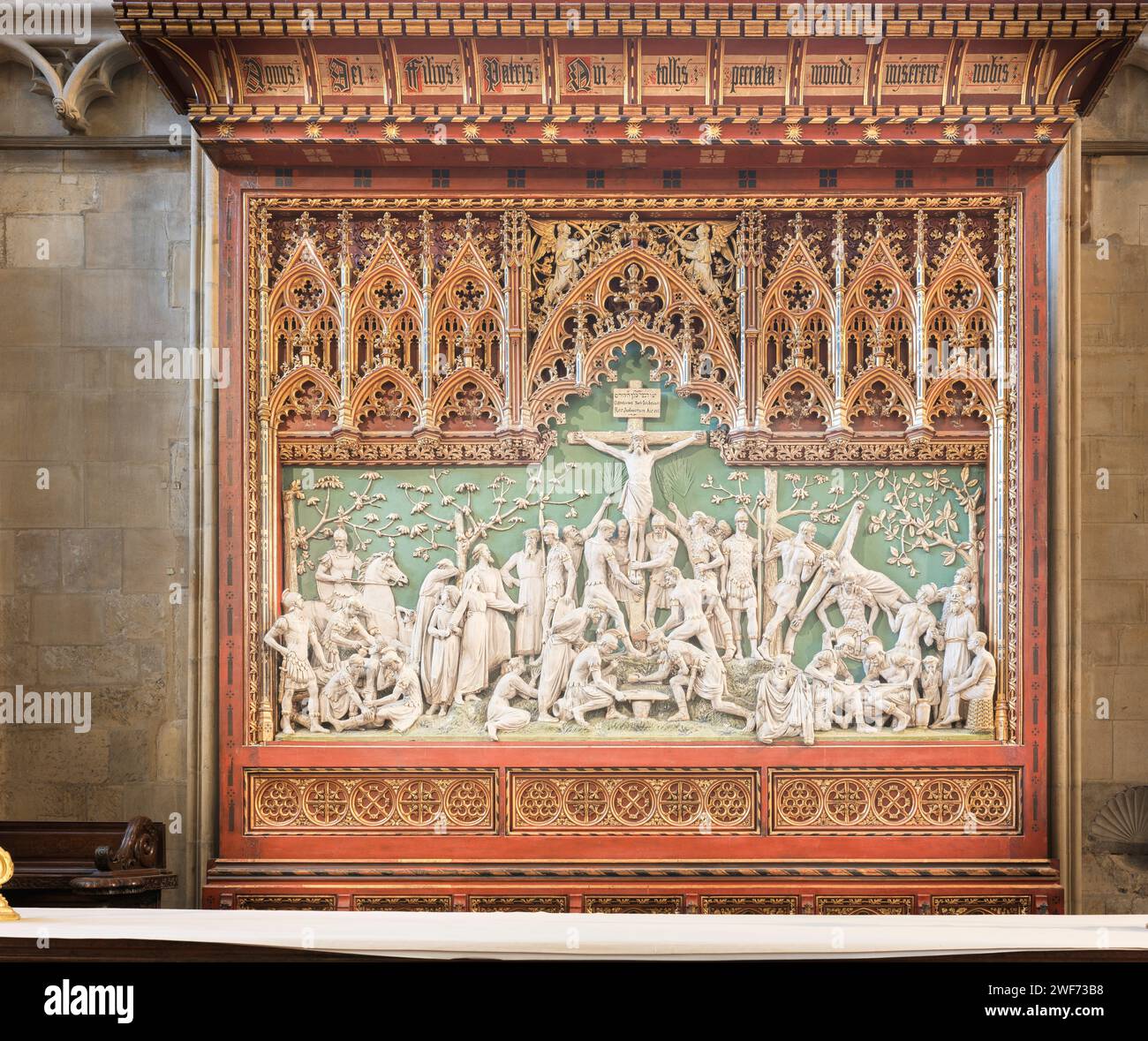 Reredos, of the crucifixion of Jesus Christ, behind the altar at a side ...