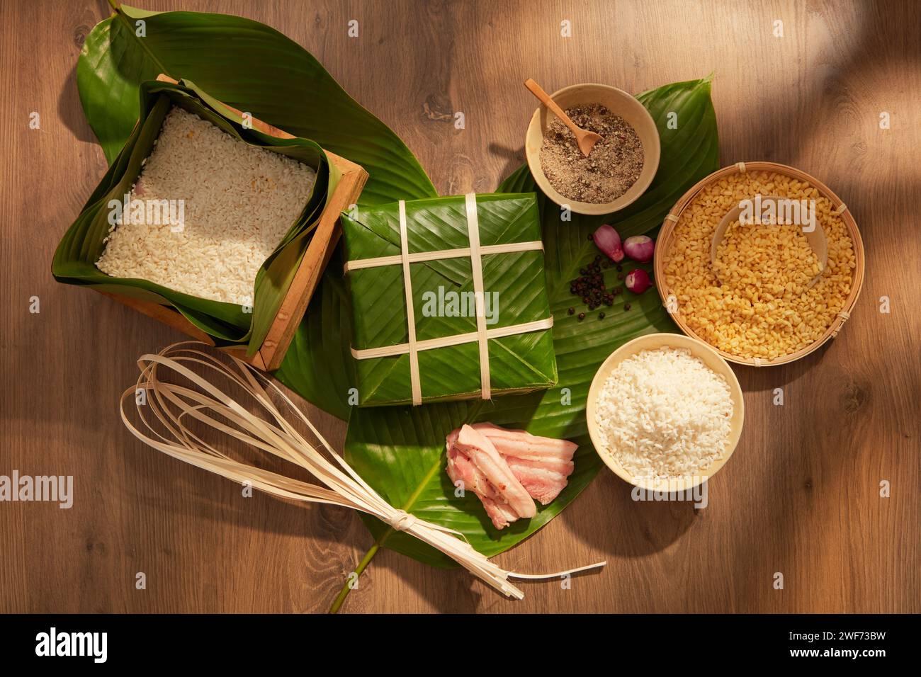 Sticky rice cake (Banh chung) and ingredients make its on wood ...