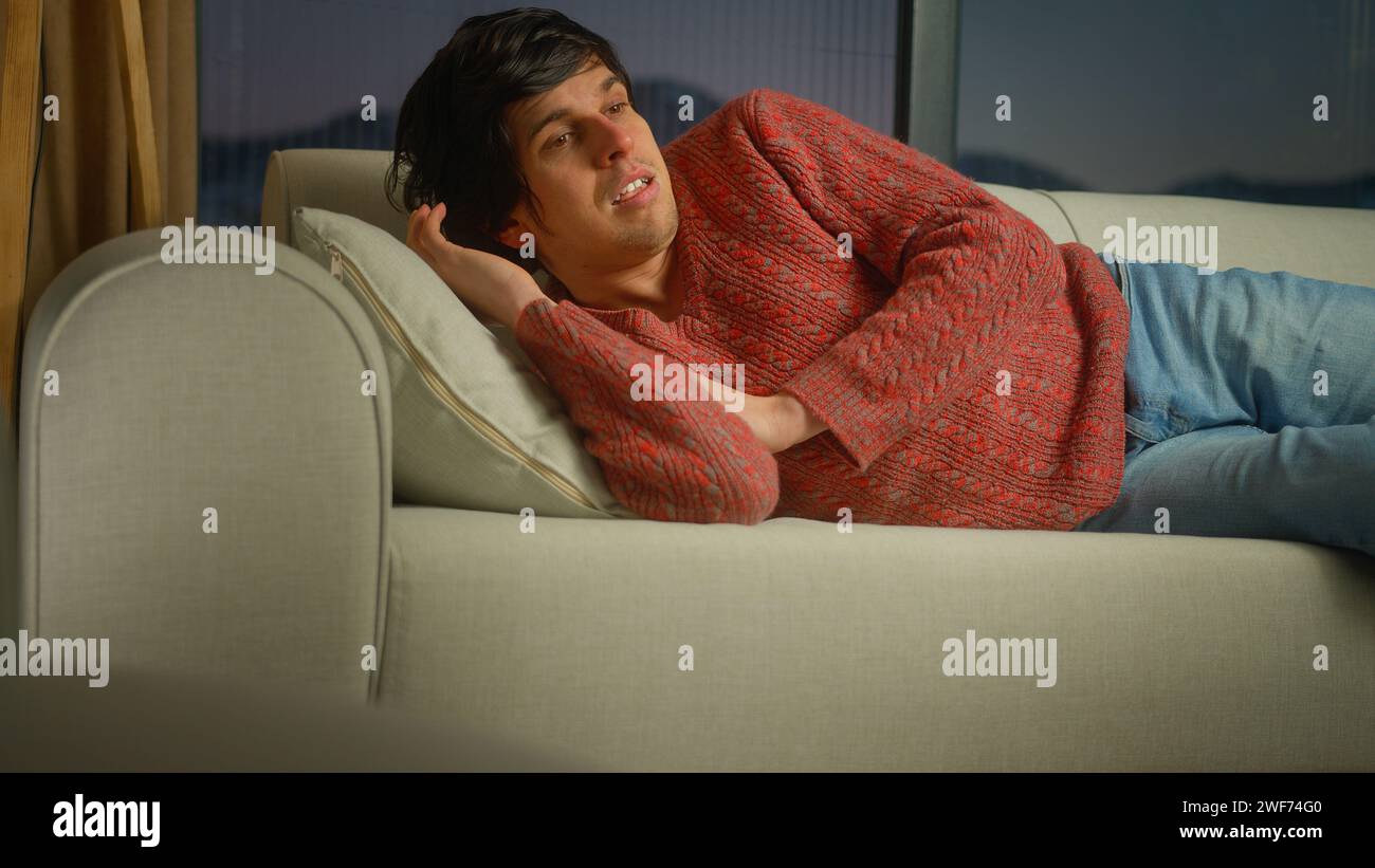 Young man suddenly wakes up while sleeping on couch due to anxiety ... Young man suddenly wakes up while sleeping on couch due to anxiety ...