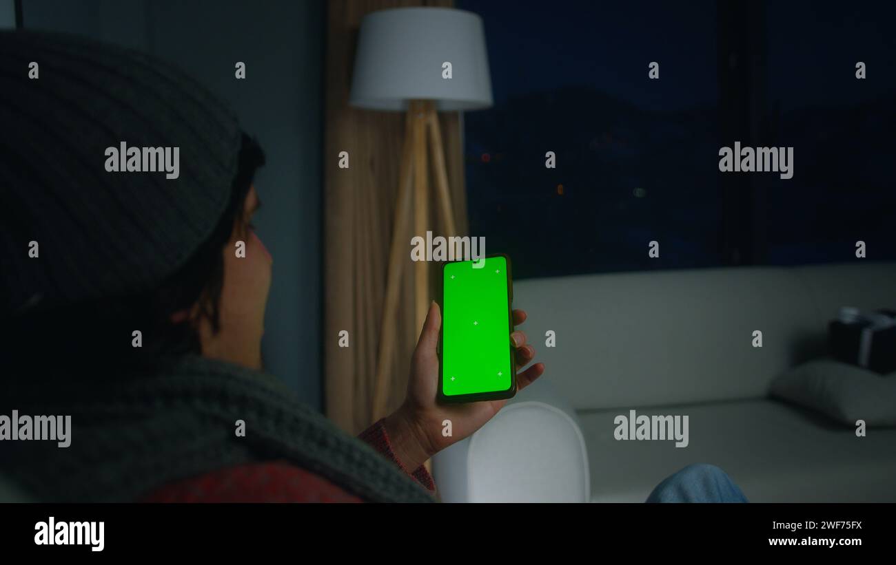 Young man using, tapping on screen smartphone with green mock-up screen ...