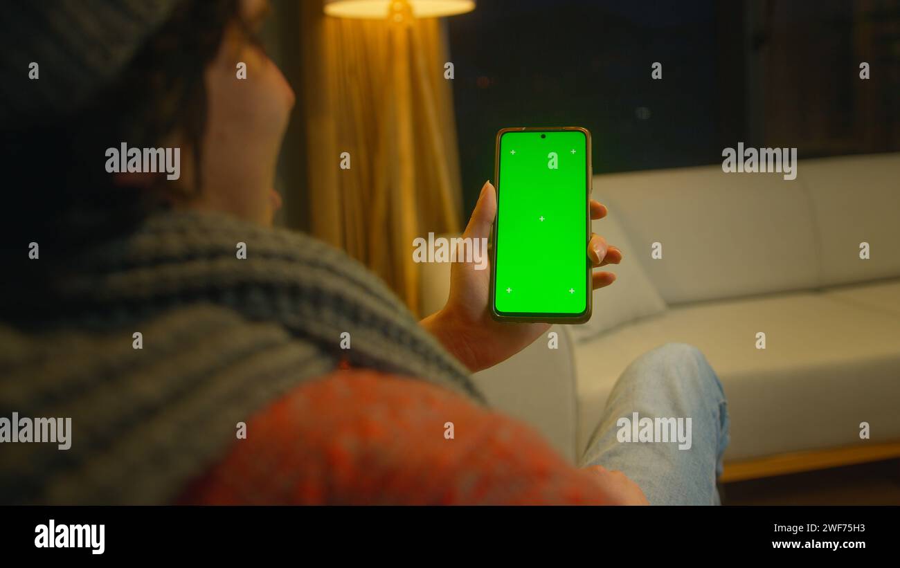 smiling man using, tapping on screen smartphone with green mock-up ...