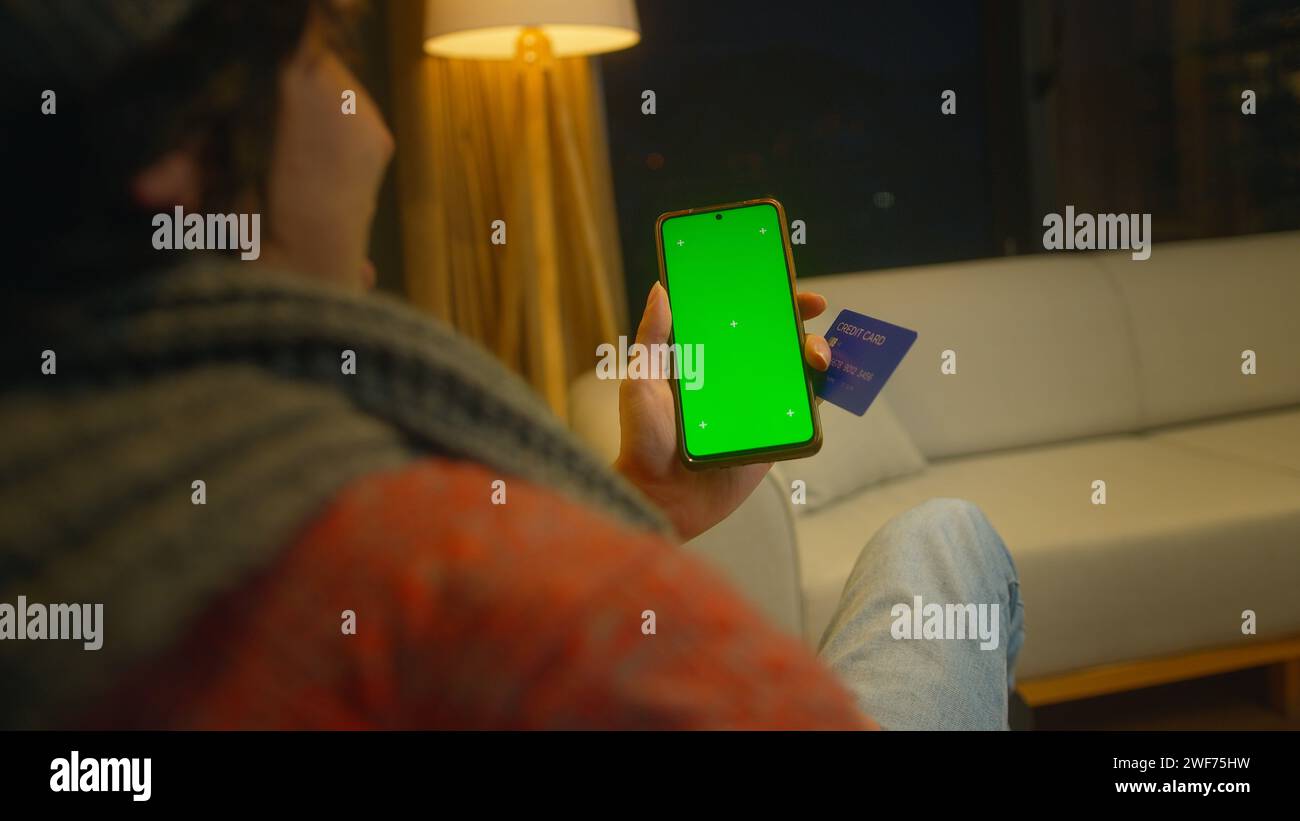 Man holding credit card, using, tapping on screen smartphone with green ...