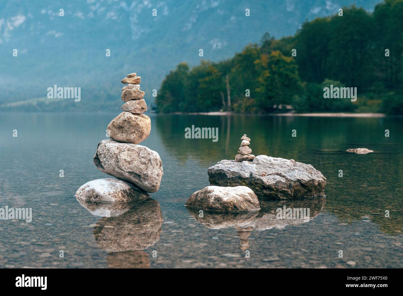 Stacked stones at lake Bohinj shoreline, selective focus Stock Photo ...