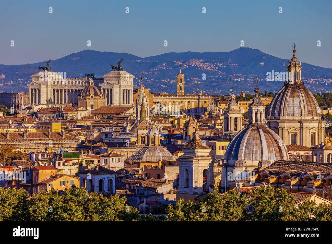City of Rome sunset cityscape with domed churches and Victor Emmanuel ...