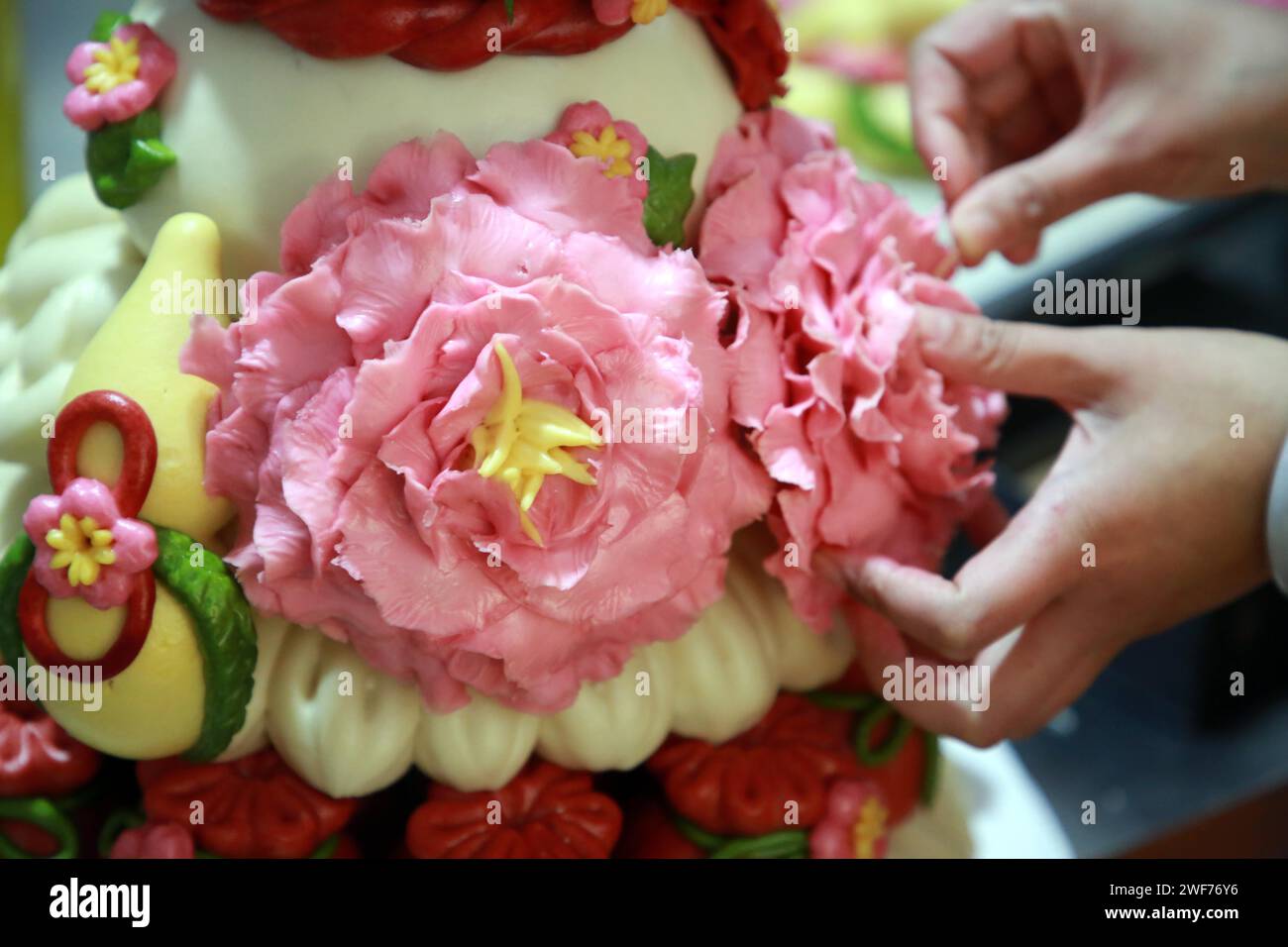 Flower-shaped steamed buns are made to celebrate the Spring Festival in ...