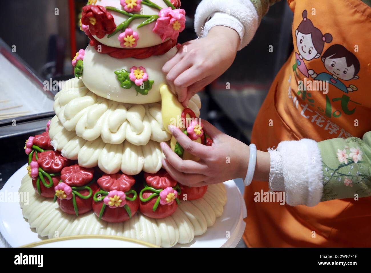Flower-shaped steamed buns are made to celebrate the Spring Festival in ...
