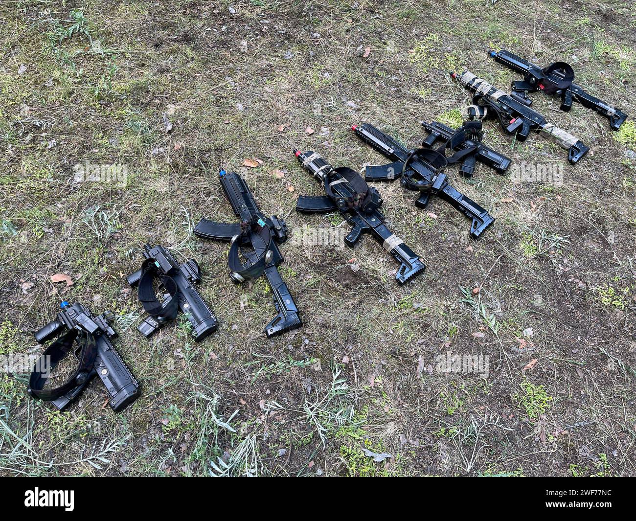 Weapons for laser tag game on the ground in forest Stock Photo - Alamy