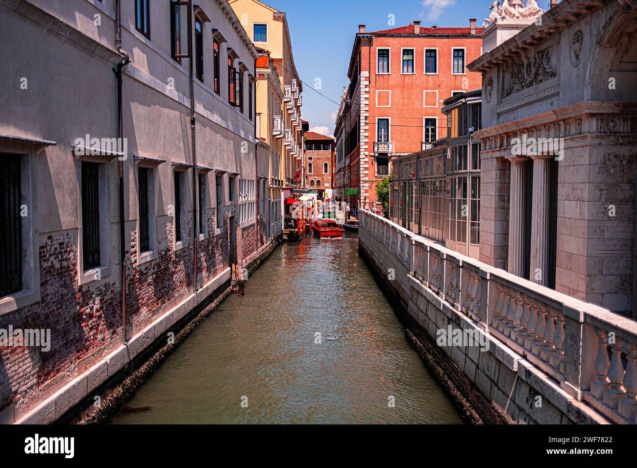 A tranquil canal winds through Venice, Italy, lined with classical ...