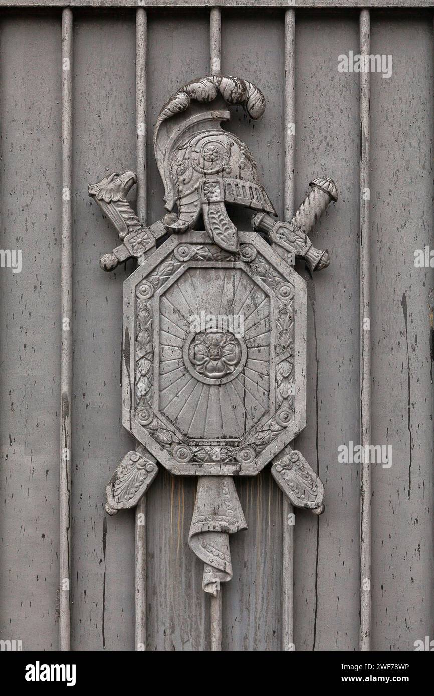 An ancient coat of arms in the form of a shield, two crossed swords and ...