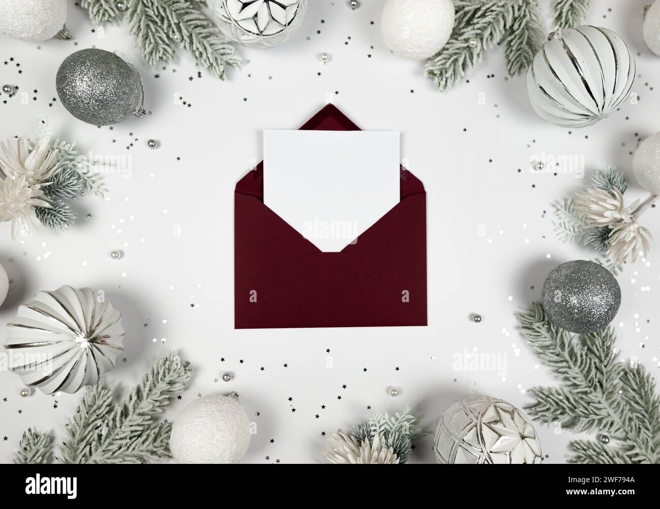 Christmas composition, red envelope, white and silver decorations, fir ...