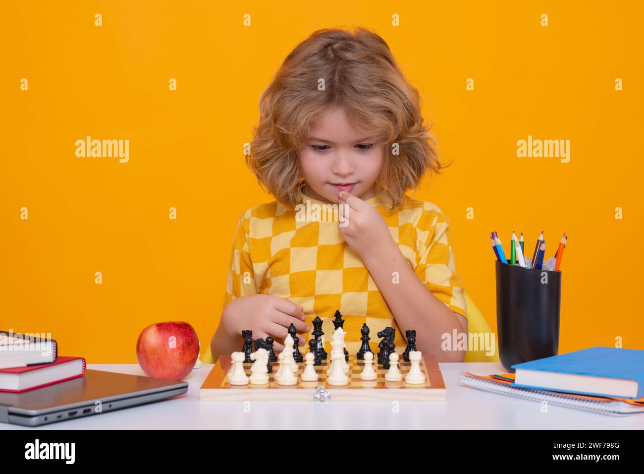 Child play chess on studio background. Kid thinking about chess. The ...