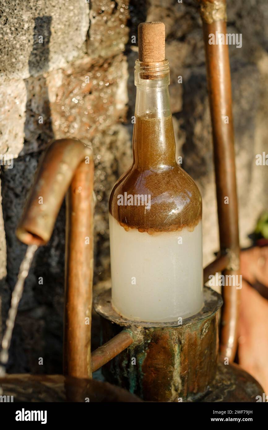 alcohol flows from a traditional distillery, on Reunion Island Stock ...