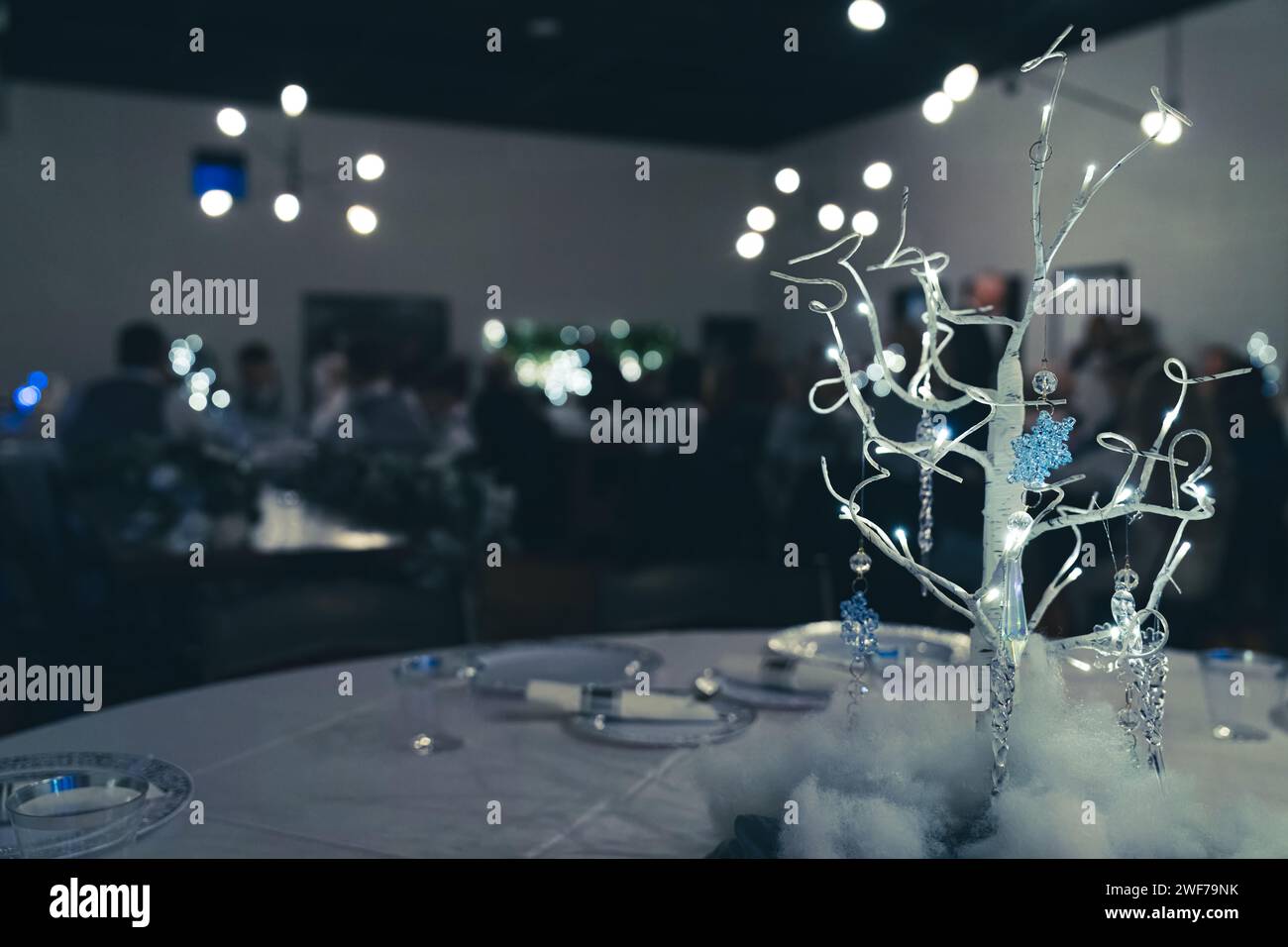 An enchanting white tree centerpiece adorned with hanging crystals and ...