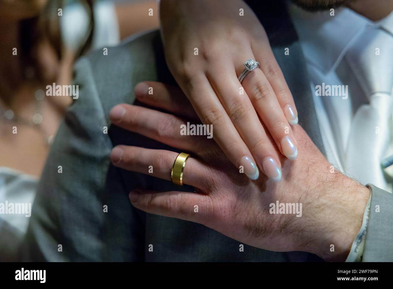 A touching moment as newlyweds, their wedding rings a symbol of their ...