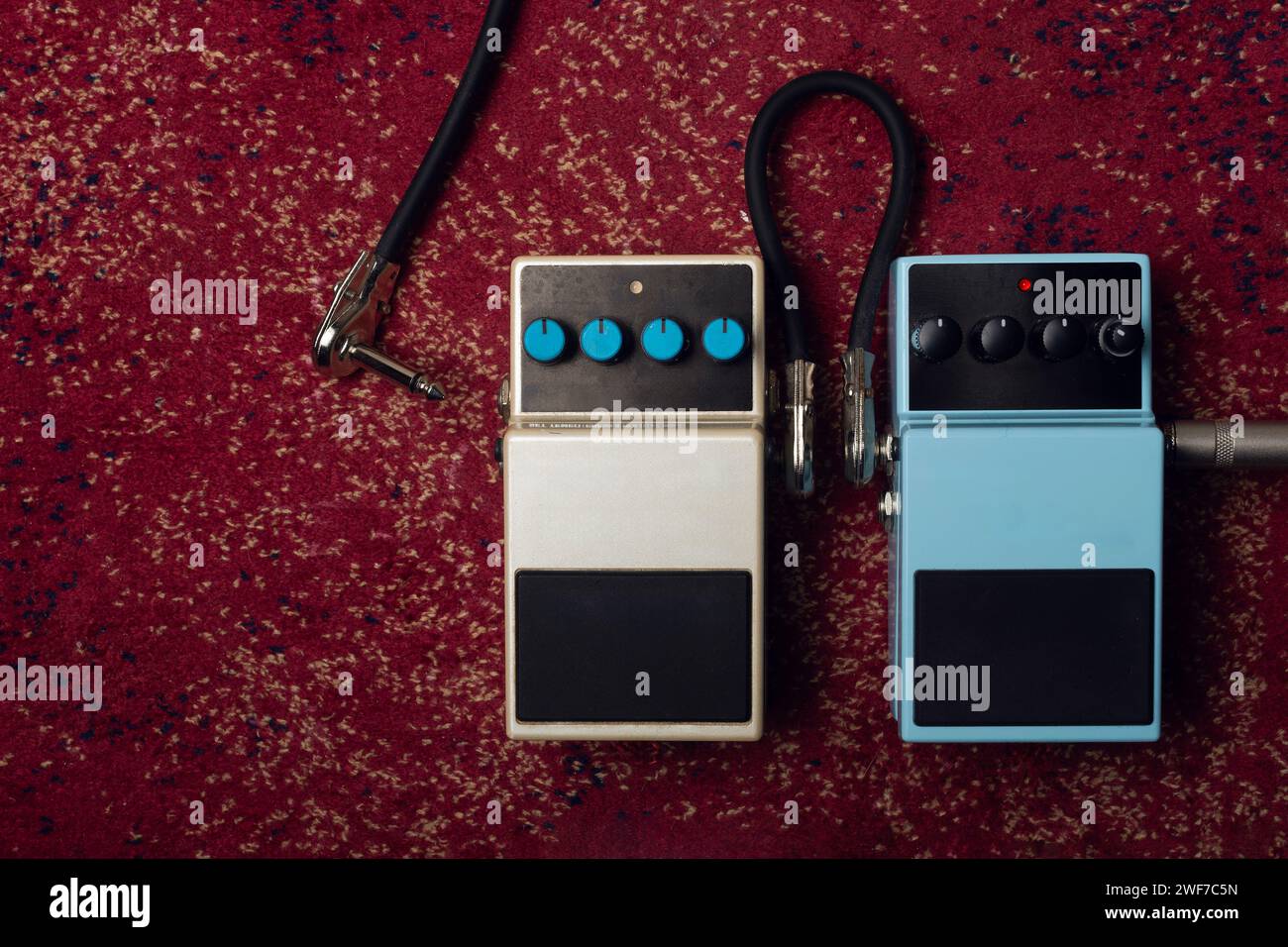 Blank white and light blue guitar pedals on red carpet Stock Photo - Alamy