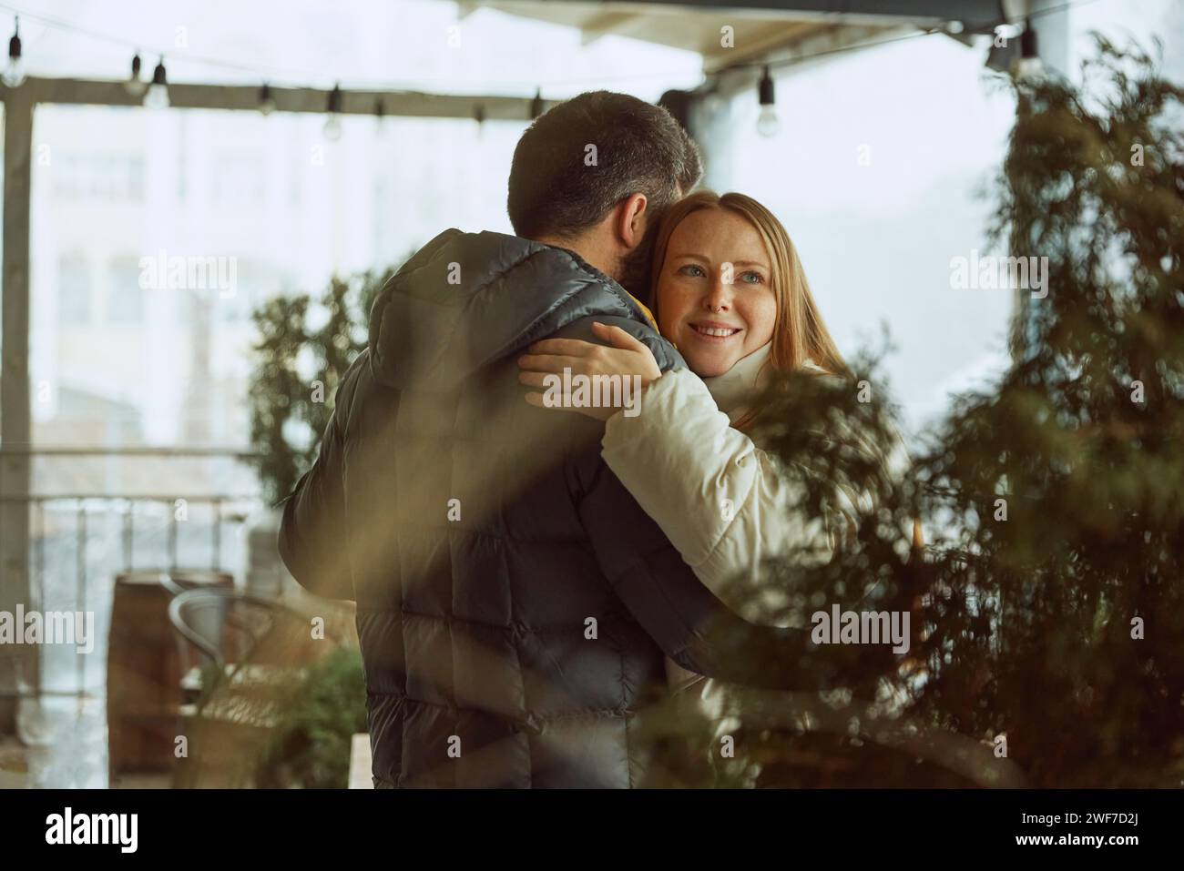 Two people, couple, man and woman hugs each other while stands outdoor ...