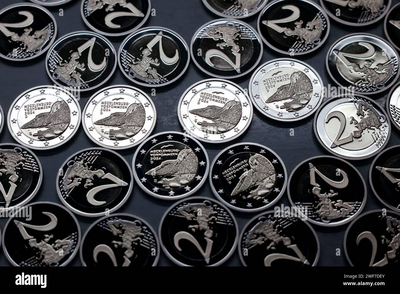 Hamburg, Germany. 29th Jan, 2024. New 2-euro commemorative coins lie on ...