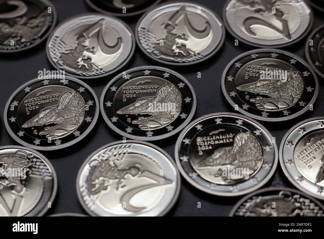 Hamburg, Germany. 29th Jan, 2024. New 2-euro commemorative coins lie on ...