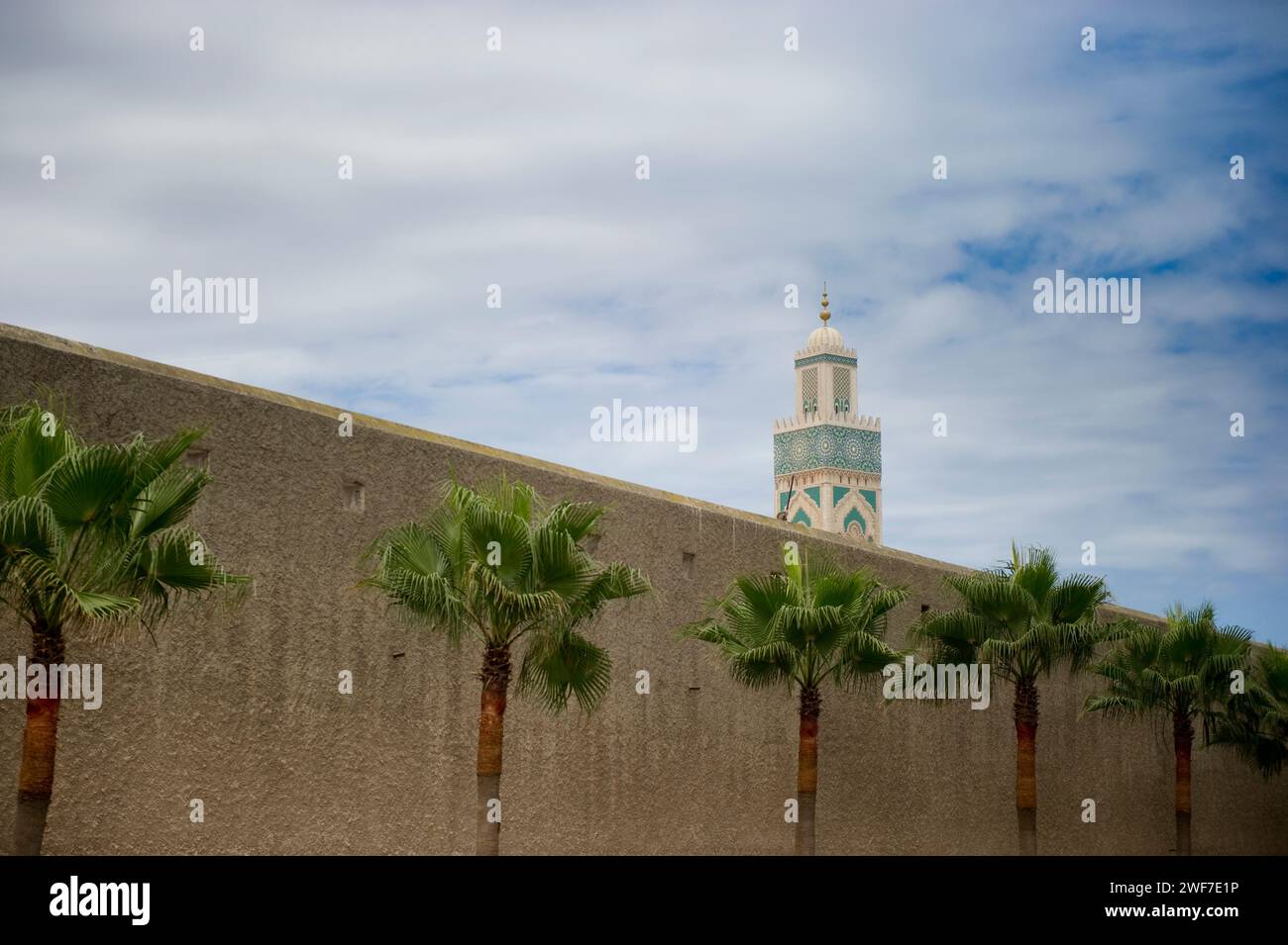 A mosque spire peeks over the retainer wall of Casablanca, Morocco ...