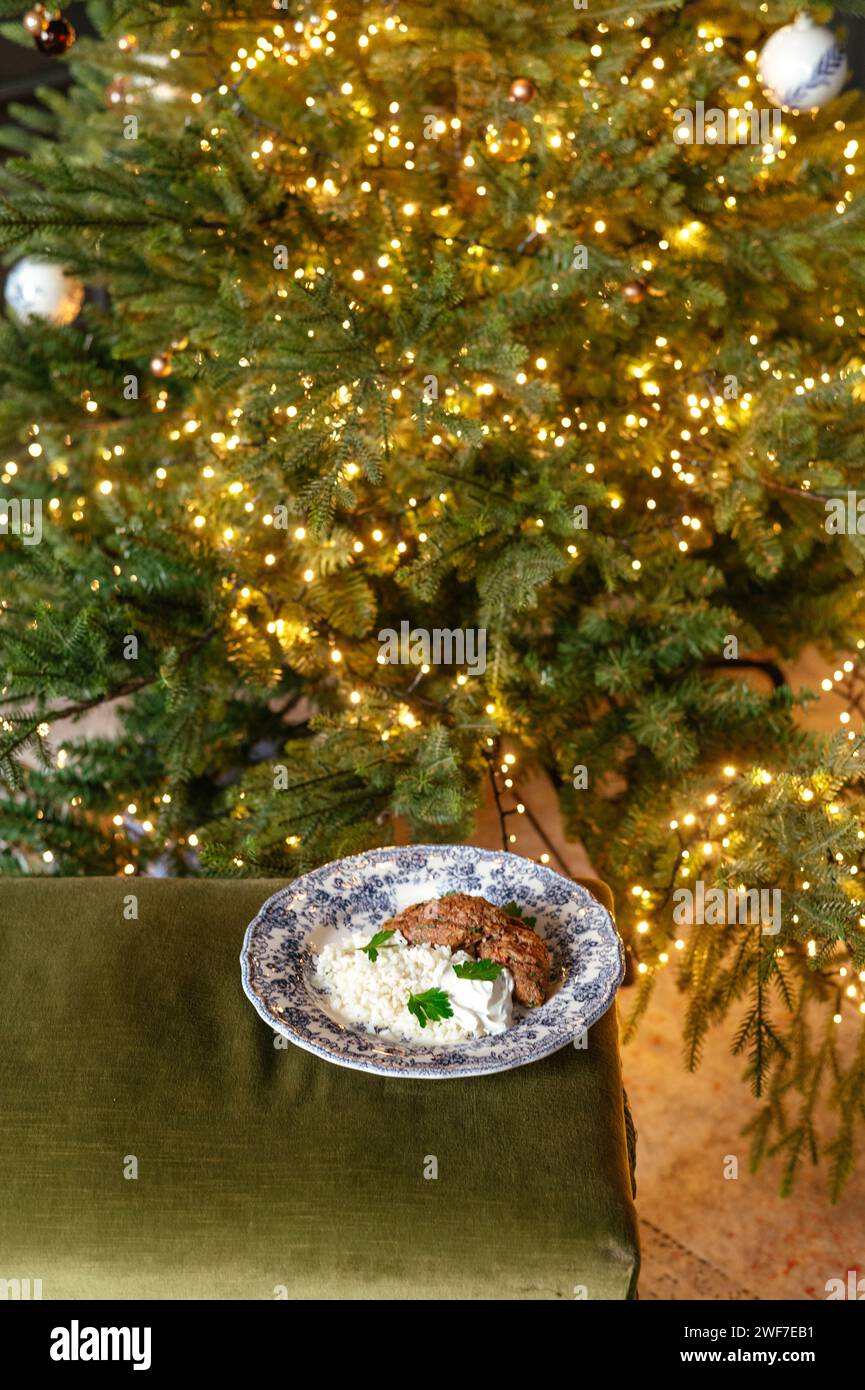 beef patty on a plate with a side dish of rice Stock Photo - Alamy
