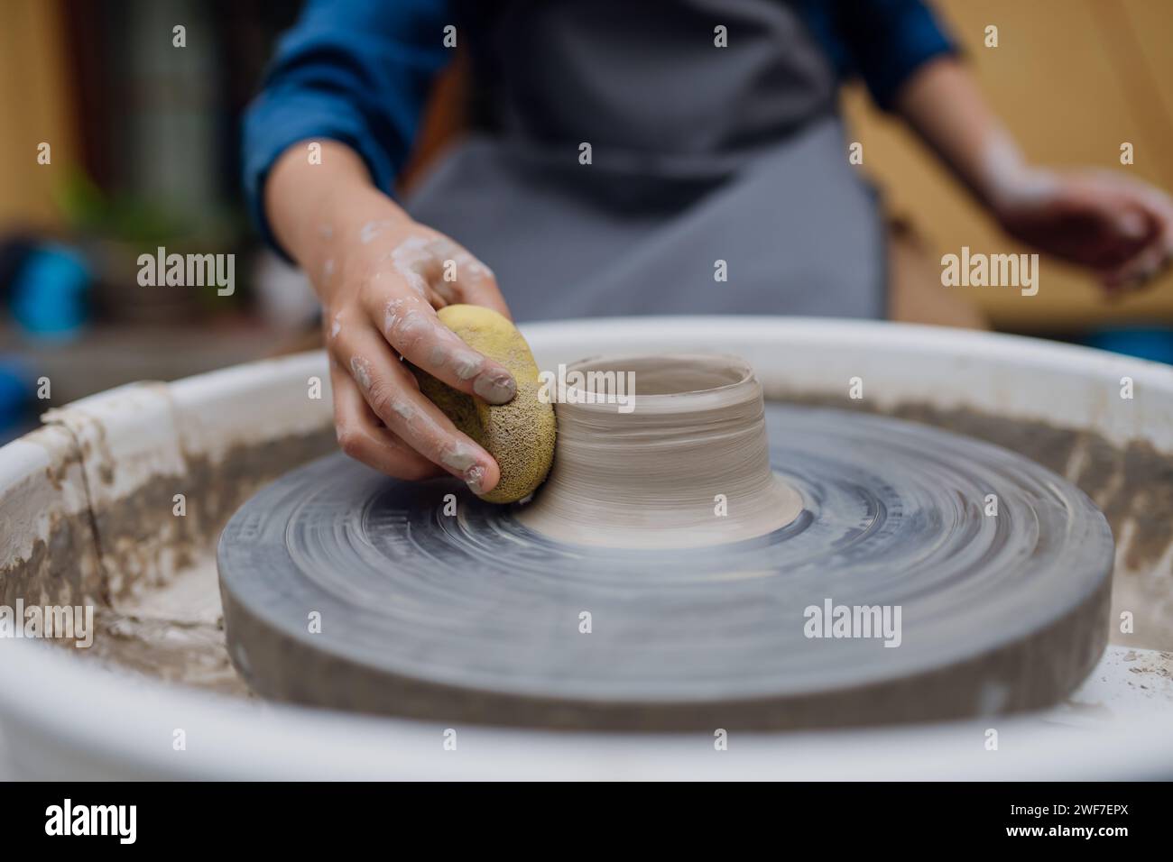 Close up woman doing pottery on pottery wheel. Child creative ...