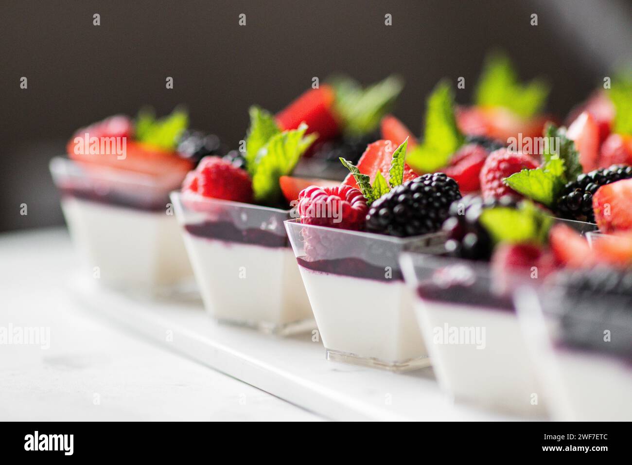 Vanilla Panna Cotta topped with mix berry fruit and mint Stock Photo ...