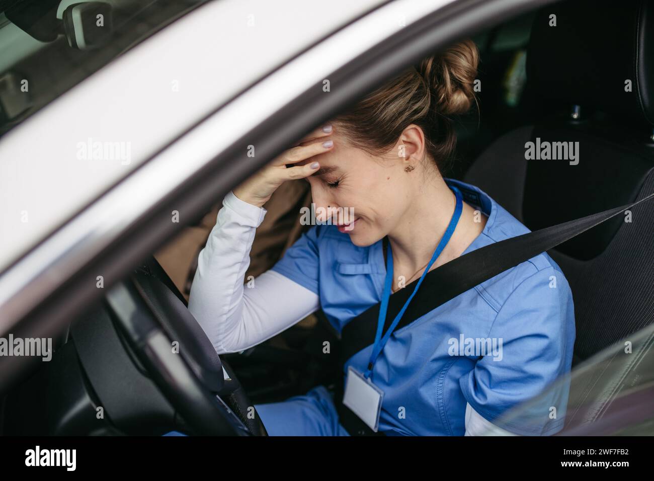 Nurse crying in car, going home after hard work day. Female doctor ...