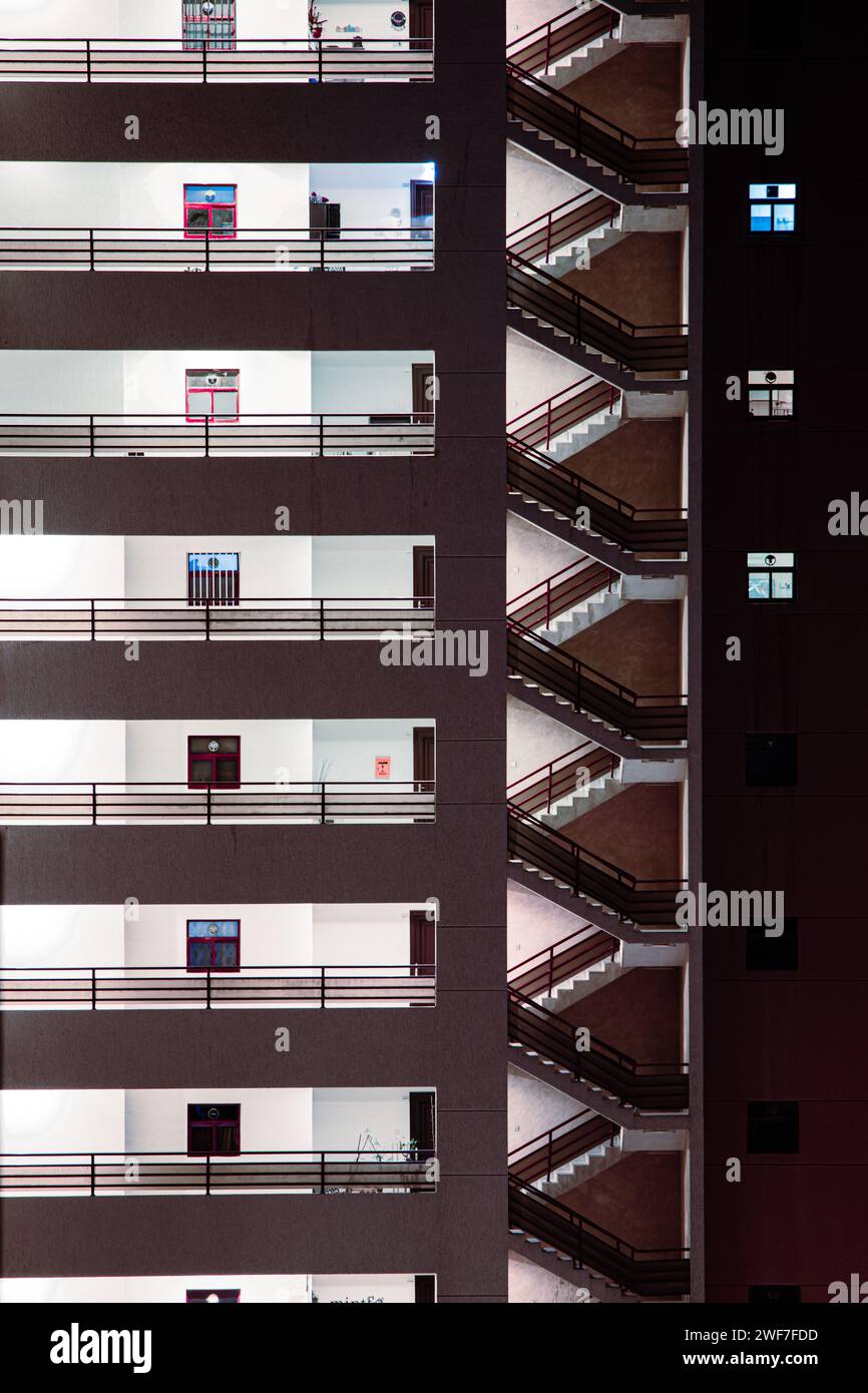 An illuminated high-rise building at night with a fire escape Stock ...