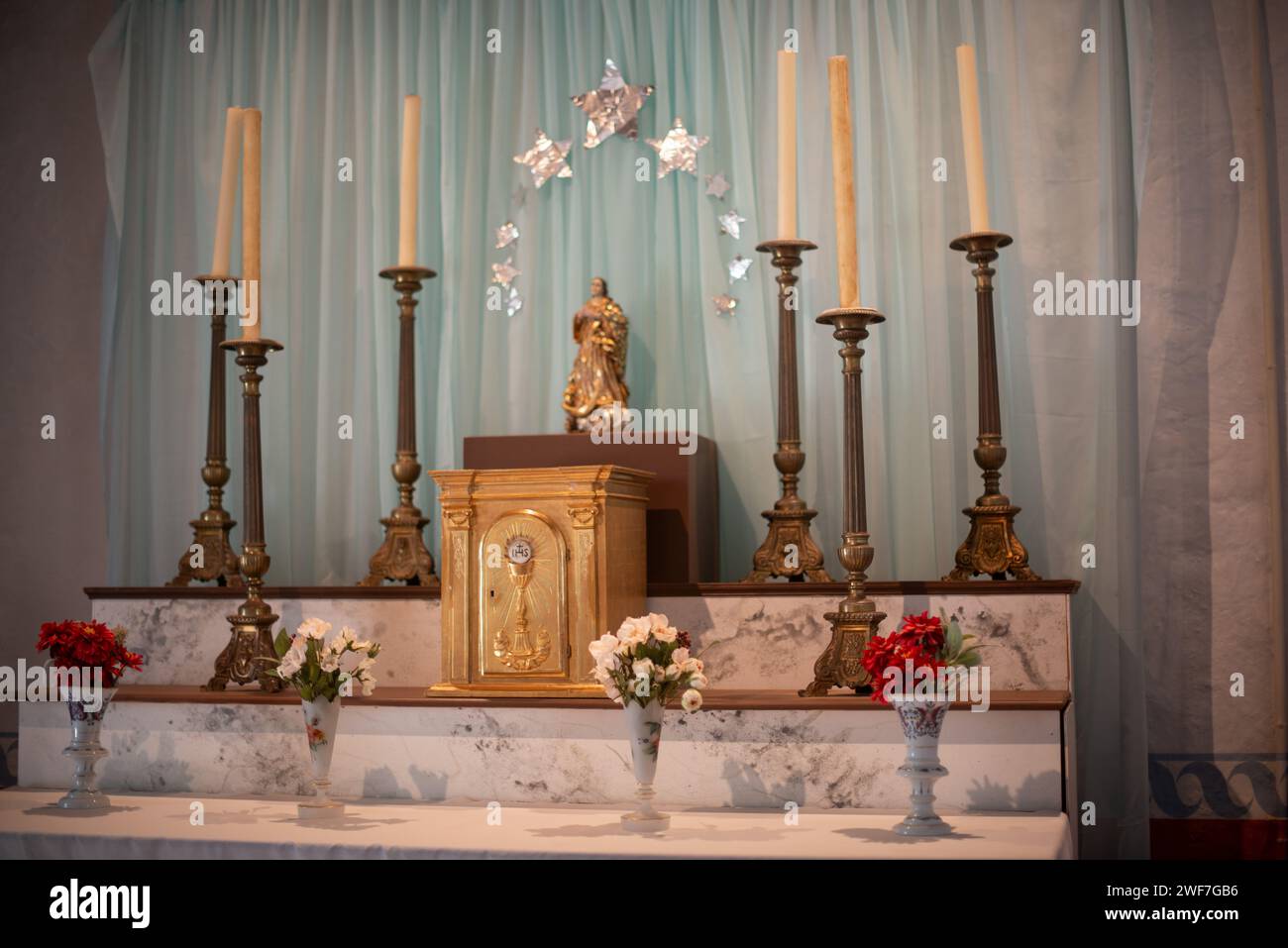 Religious Altar with Candles and Flowers Stock Photo - Alamy