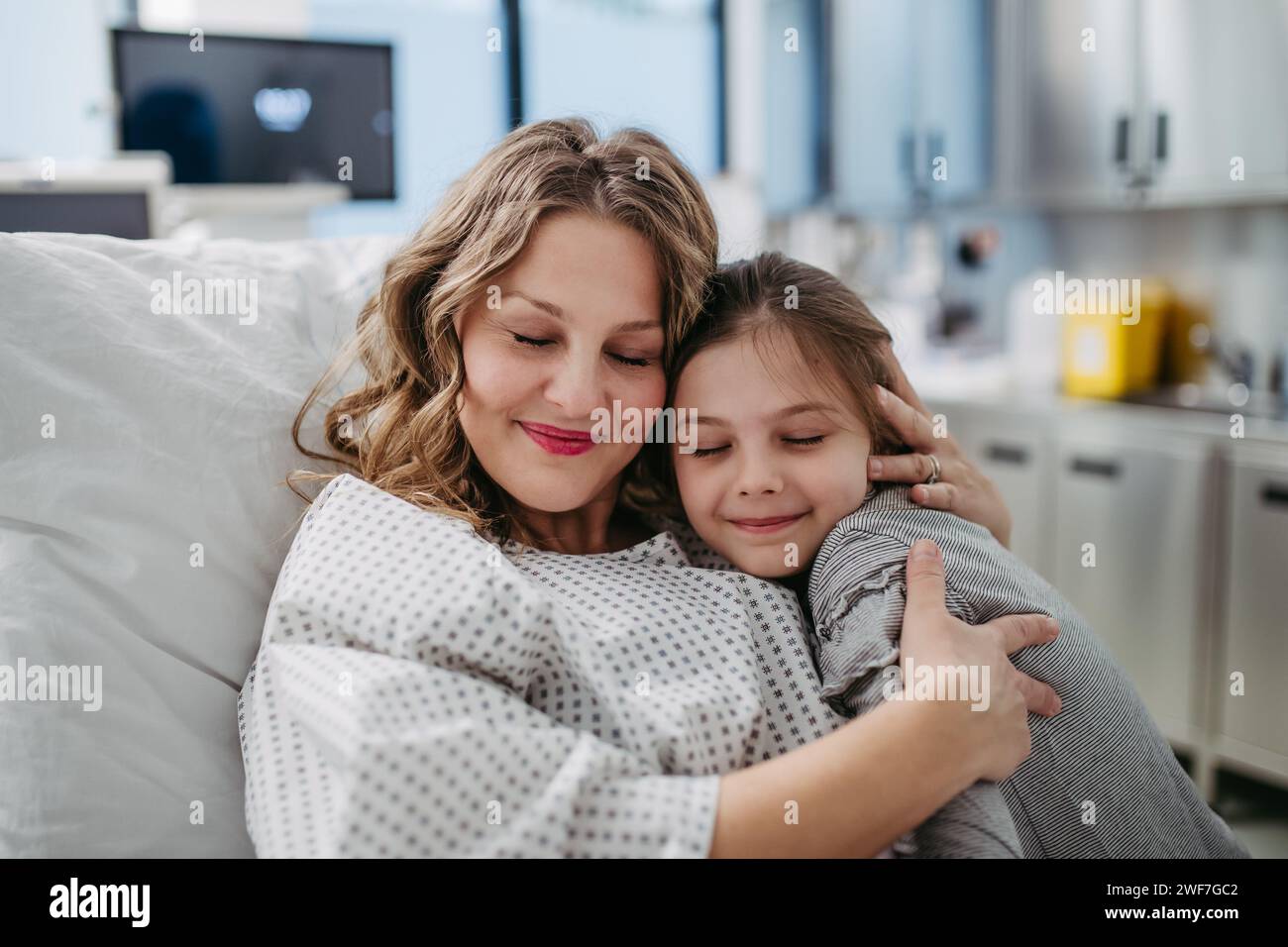 Daughter visiting mother in hospital after surgery. Emotional support ...