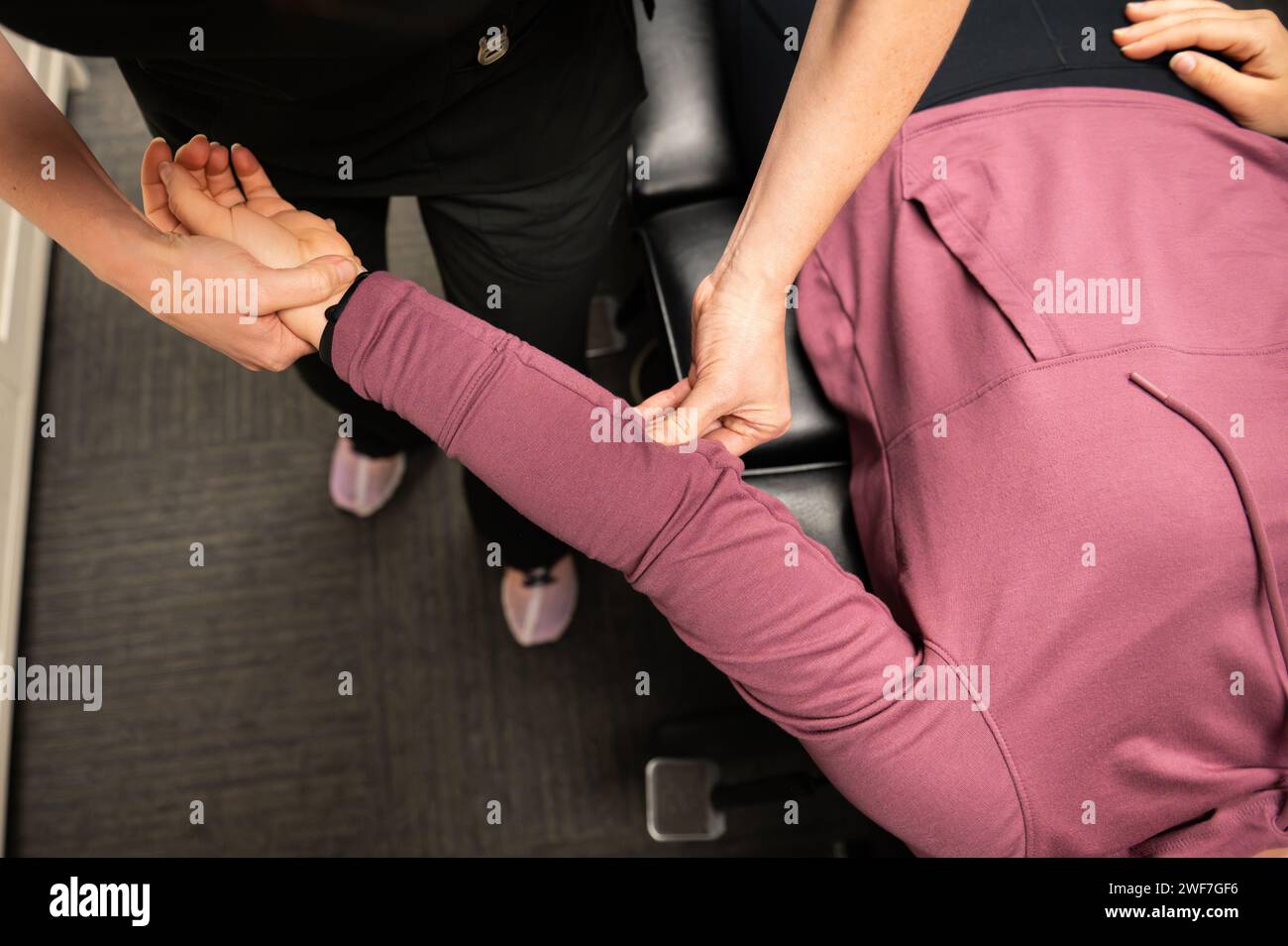 Chiropractic connection: Holding hand, arm adjustment, wellness Stock ...