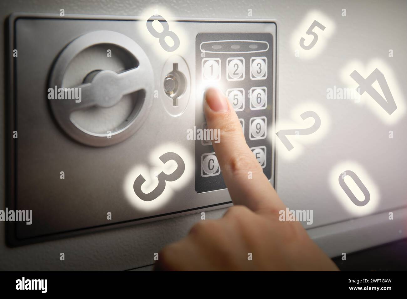Woman pressing buttons on keypad to lock steel safe, closeup. Numbers symbolizing code ...