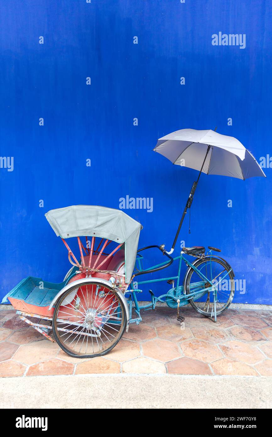 Old rickshaw with an electric-blue wall behind Stock Photo - Alamy