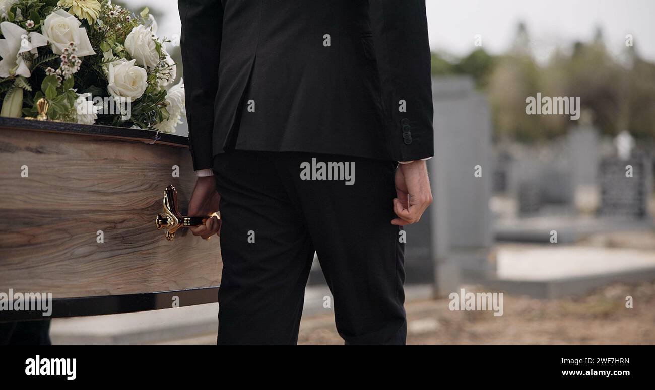 Coffin, hands and man walking at funeral ceremony outdoor with ...